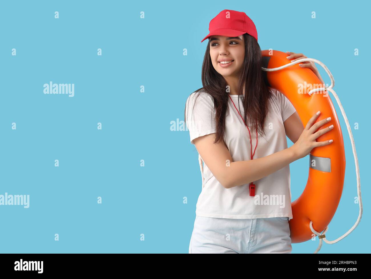 Female lifeguard with ring buoy on blue background Stock Photo - Alamy