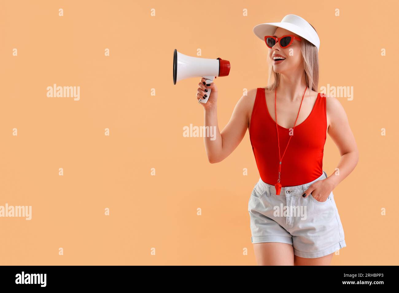 Female lifeguard with megaphone on beige background Stock Photo - Alamy