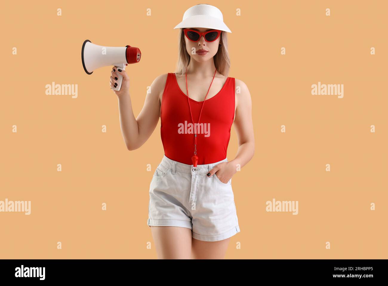 Female lifeguard with megaphone on beige background Stock Photo - Alamy