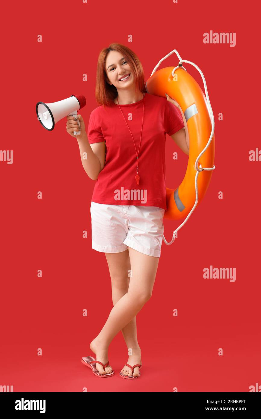 Female lifeguard with ring buoy and megaphone on red background Stock ...