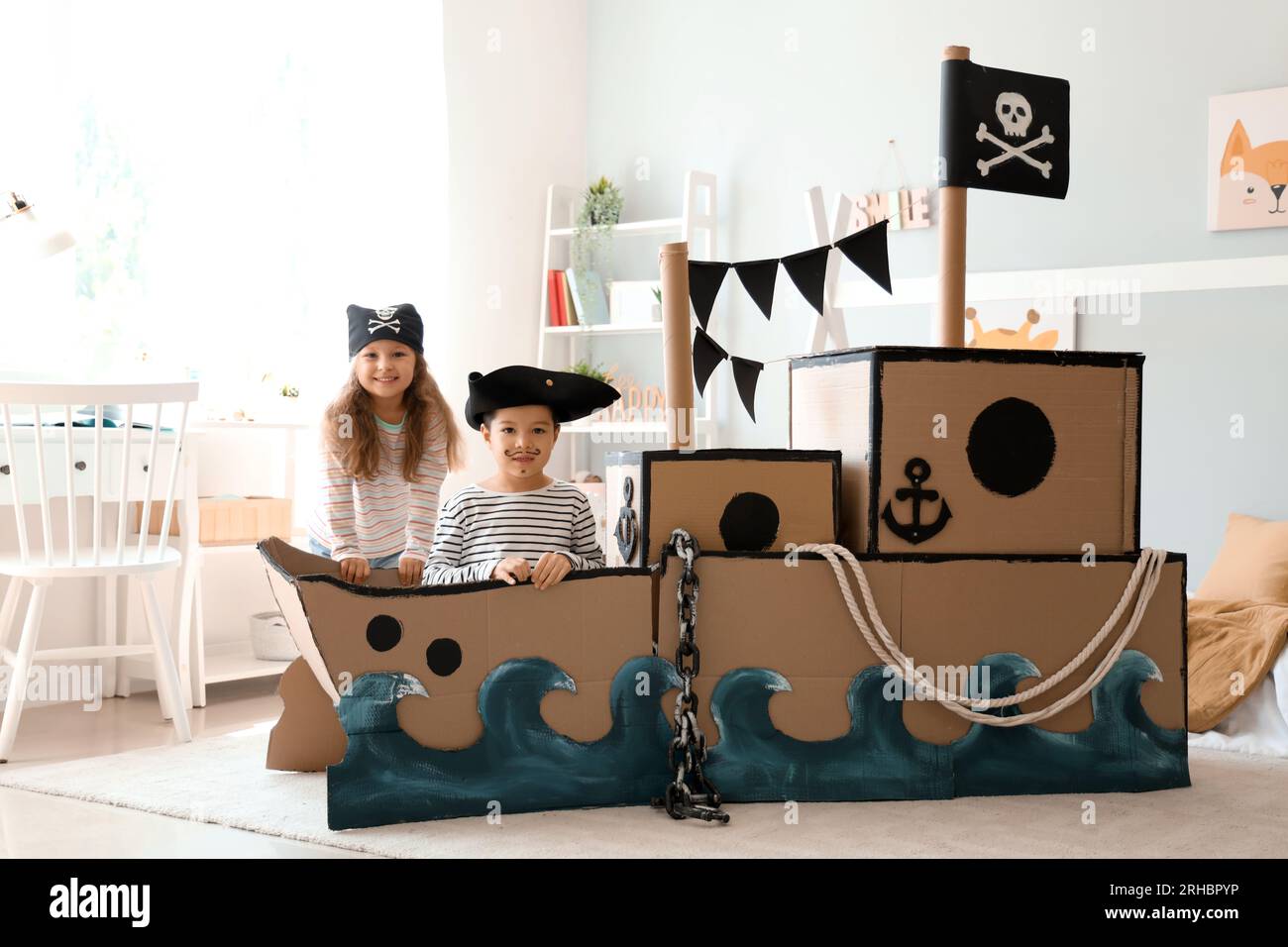 Cute little pirates playing in cardboard ship at home Stock Photo - Alamy