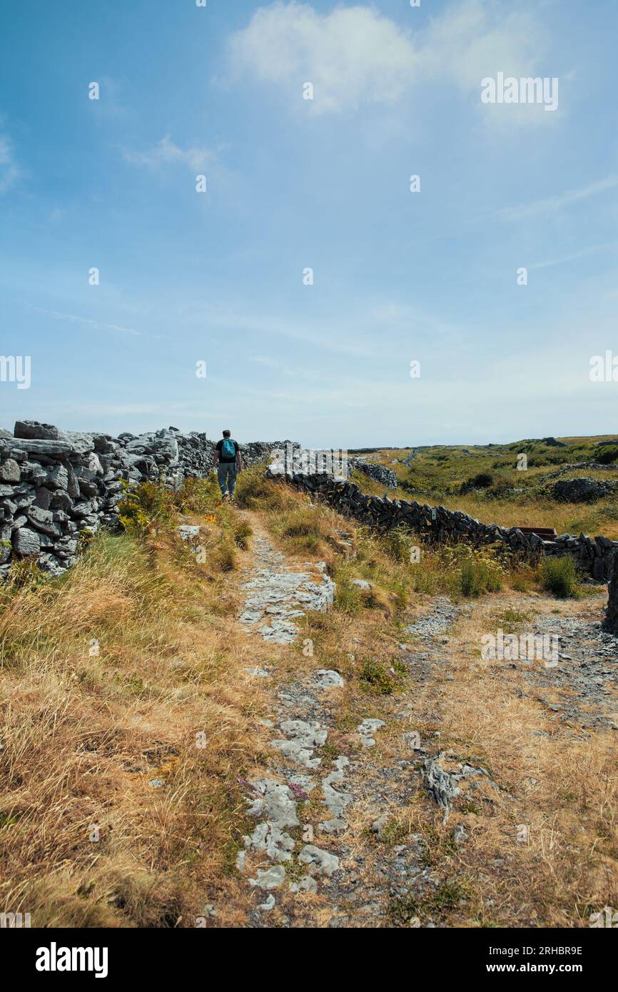 A lone hiker explores the wilderness of Inishmore Island of the Aran ...