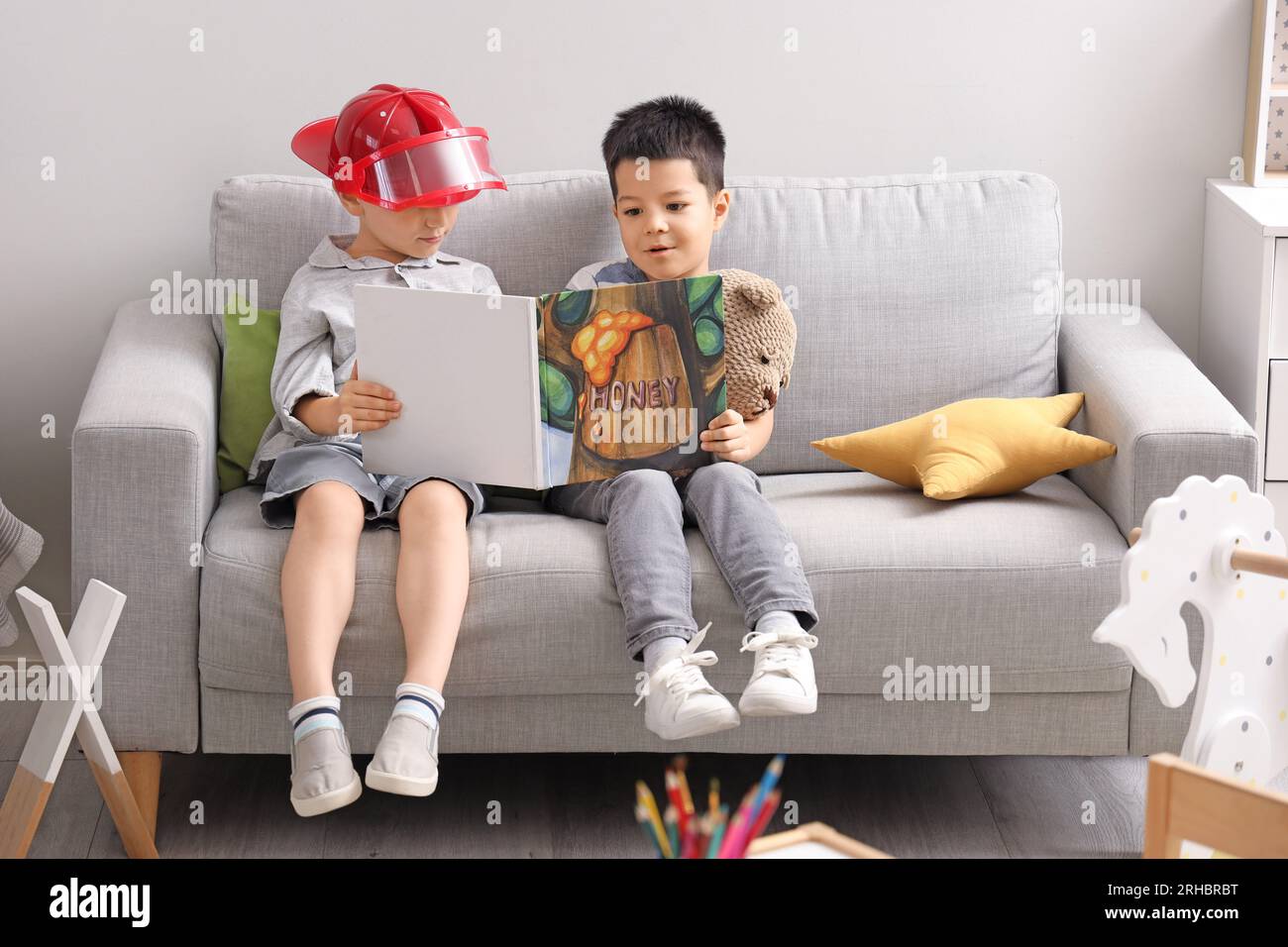 Cute little boys reading story at home Stock Photo - Alamy