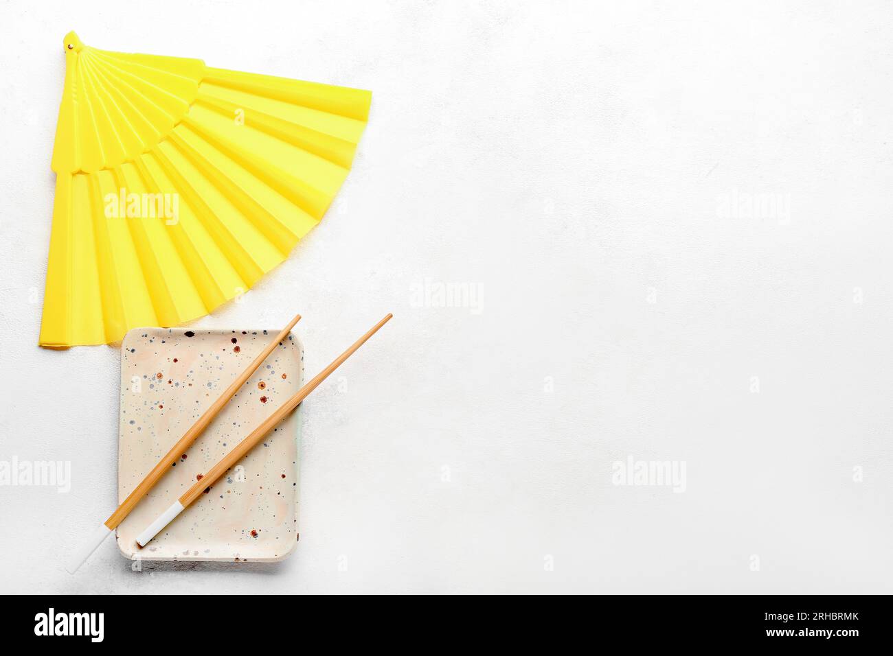 Chinese fan with plate and chopsticks on white background Stock Photo ...