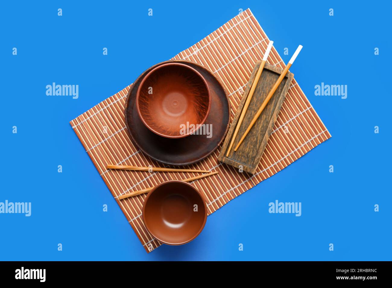Chinese table setting on blue background Stock Photo - Alamy