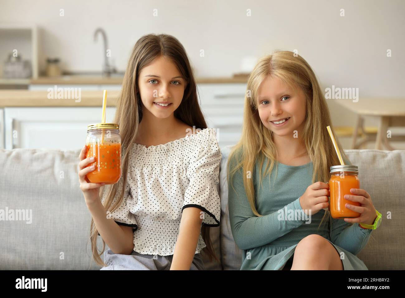 Little girls with glass jars of juice at home Stock Photo - Alamy