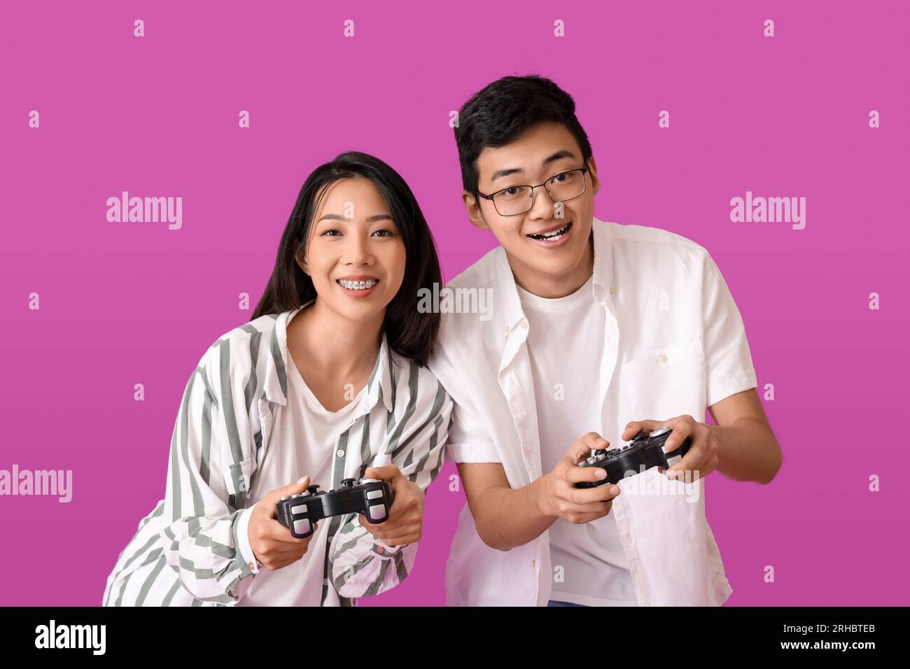 Asian friends playing console hi-res stock photography and images - Alamy