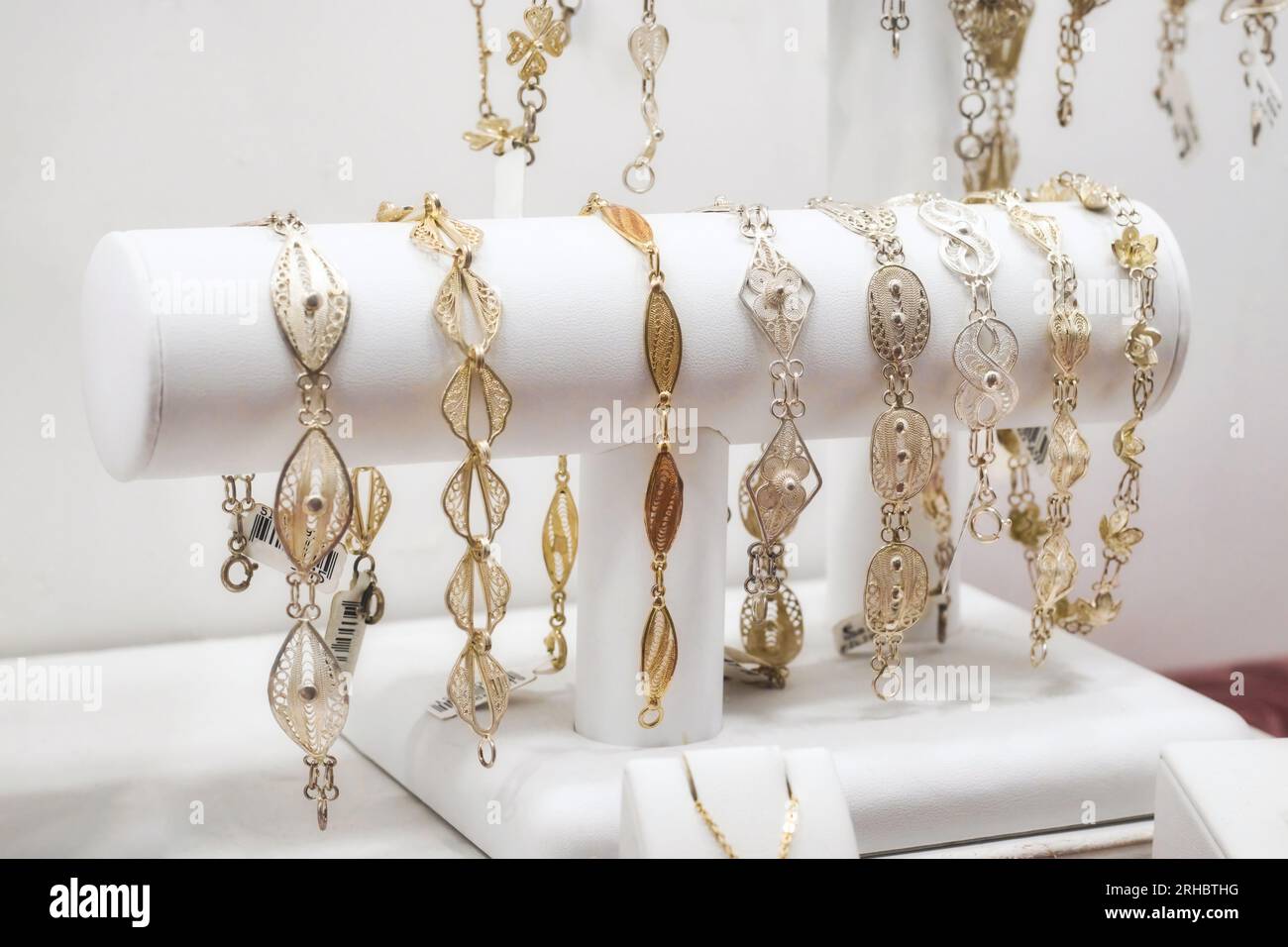 A collection of gold and silver filigree women's bracelets on display ...