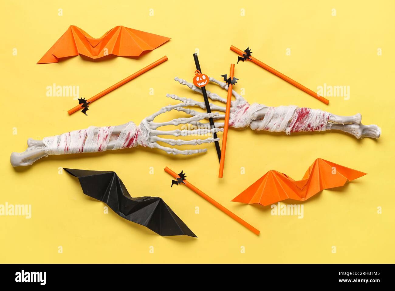 Skeleton hands with straws and paper bats for Halloween celebration on ...