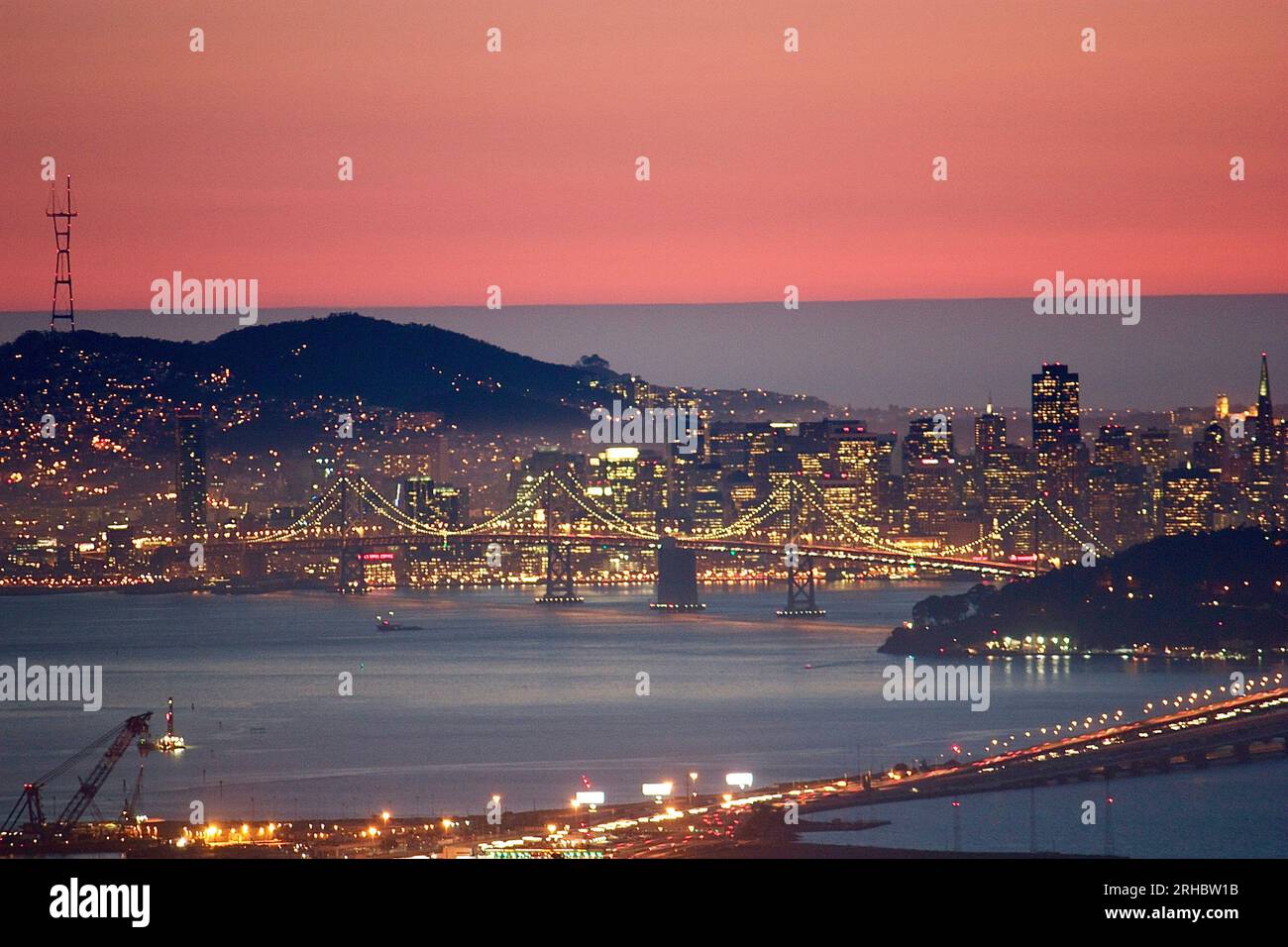 Aerial view of Bay Bridge and cityscape illuminated at night, San ...