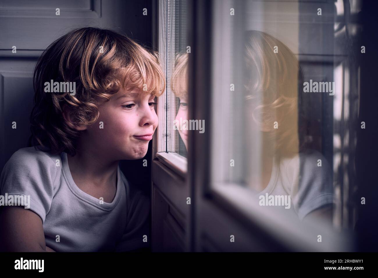 Funny little bot with curly blond hair in white t shirt pouting lips ...