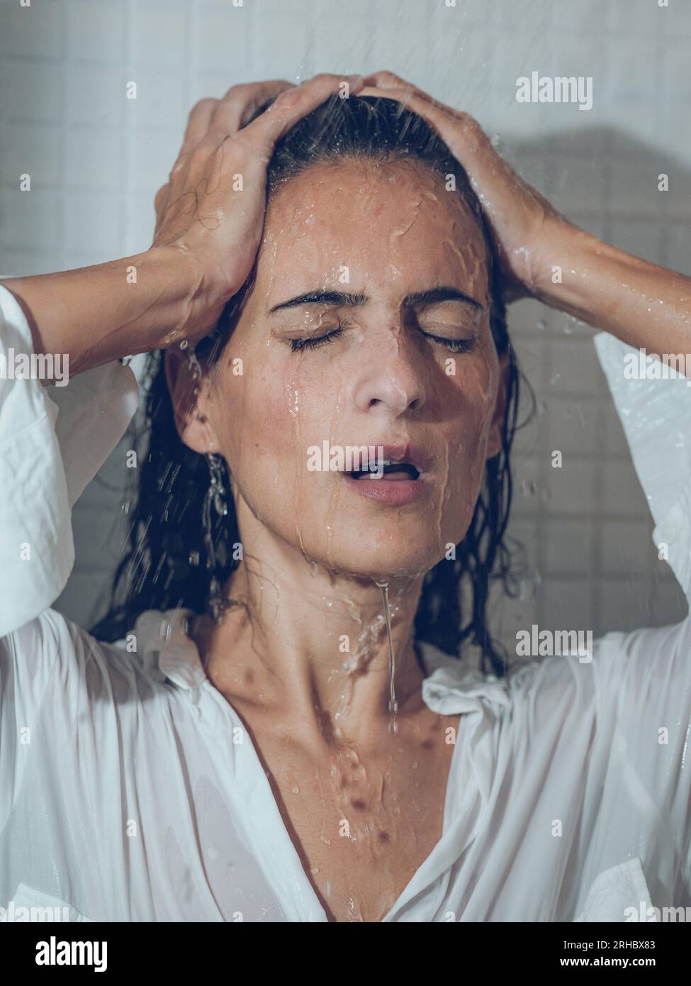 Hopeless lady with long hair and closed eyes opening mouth and touching ...