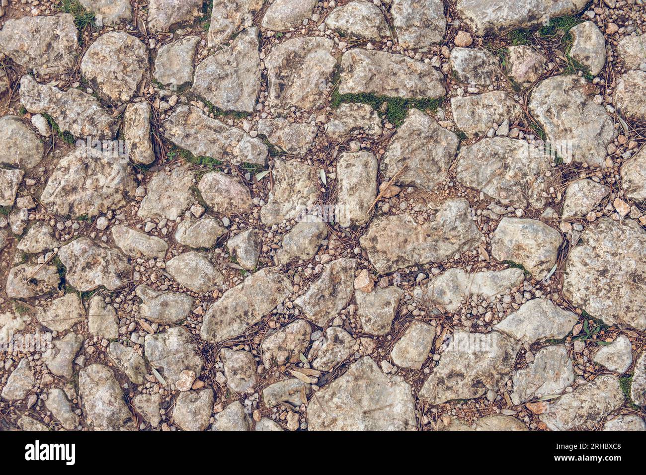Top view of rough stone path fragment with textured surface in daytime ...