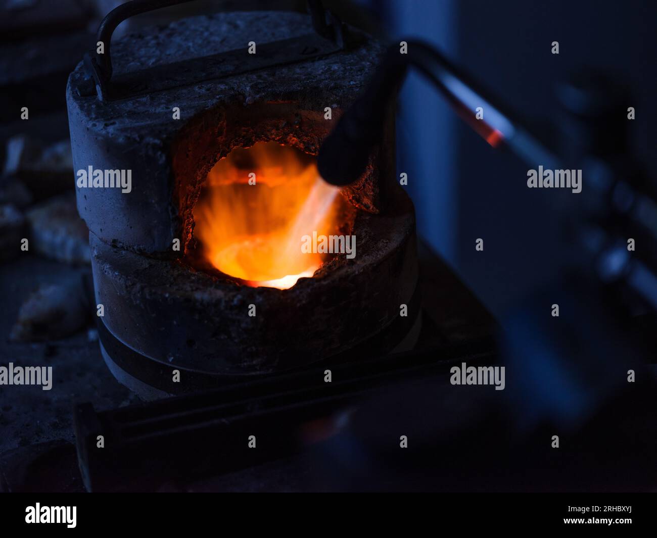 High angle of running gas torch liquating metal in round furnace in ...