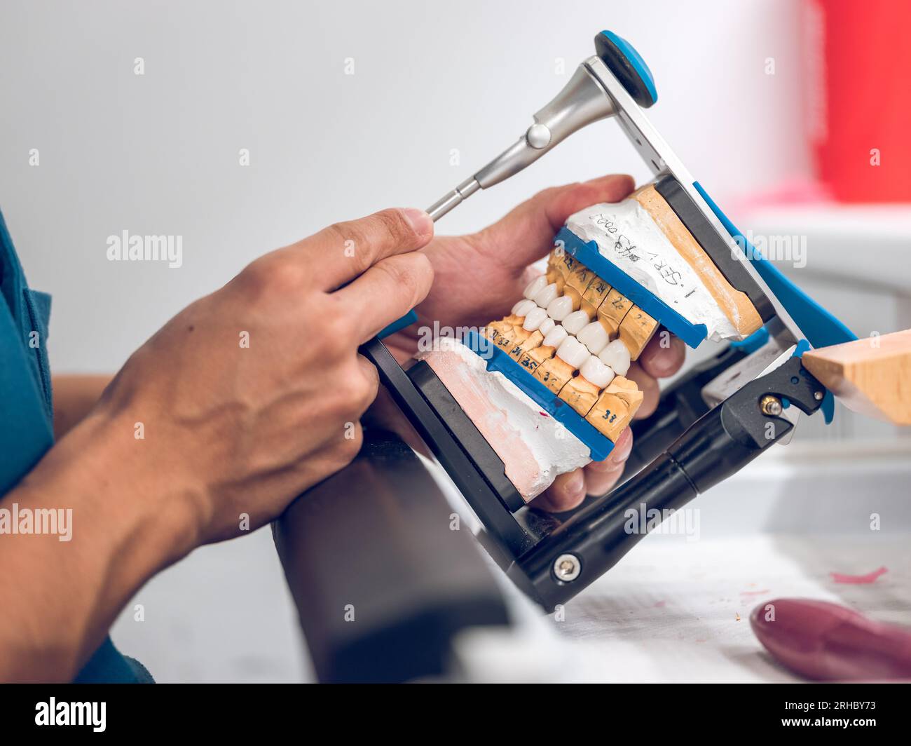 Crop unrecognizable male dentist technician using special caliper of ...