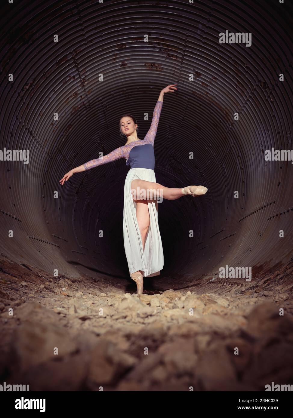 Full body of graceful female ballet dancer in pointe shoes raising leg ...