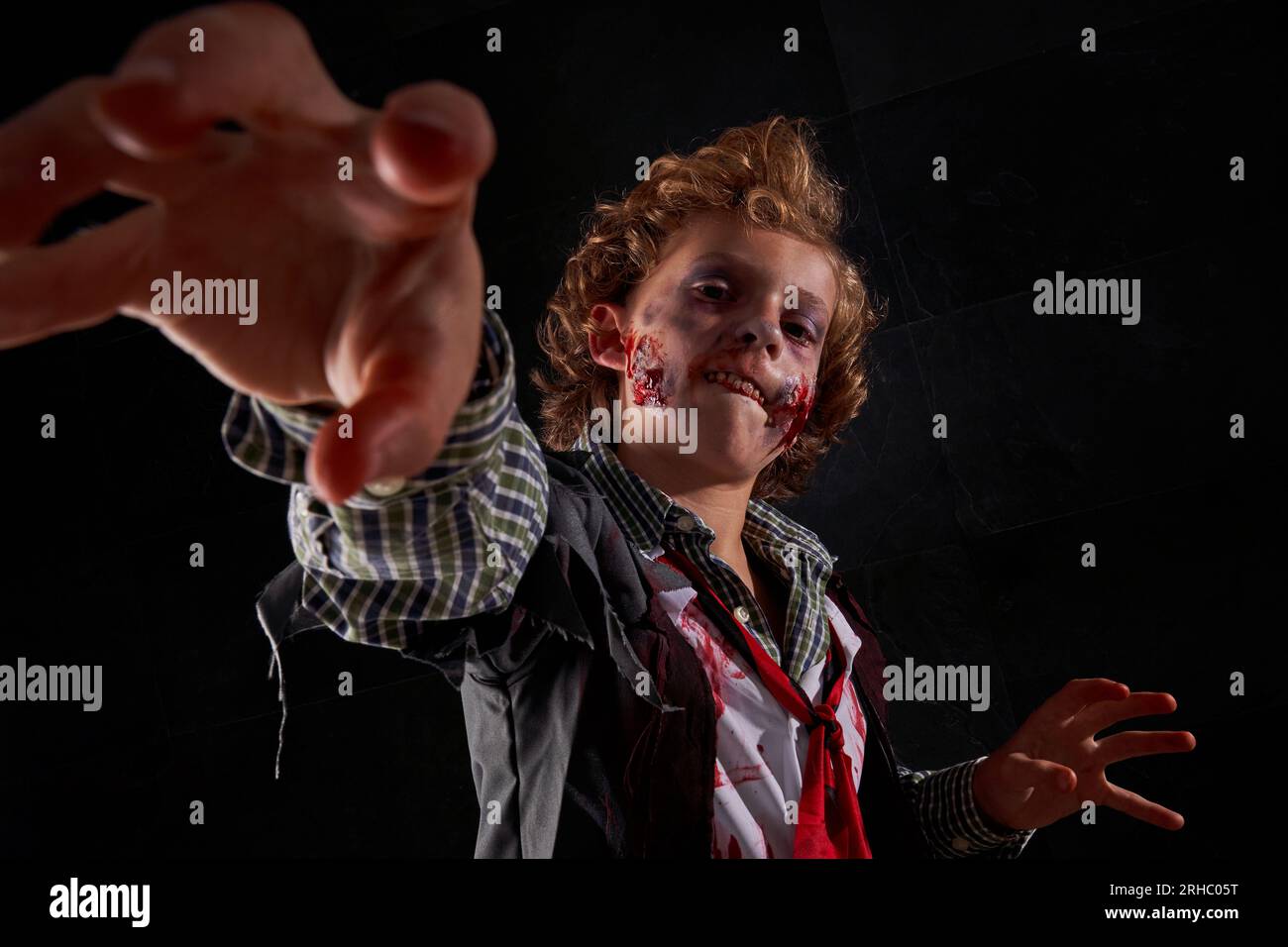 Stock photo of a boy disguised as a zombie with blood with his arms ...