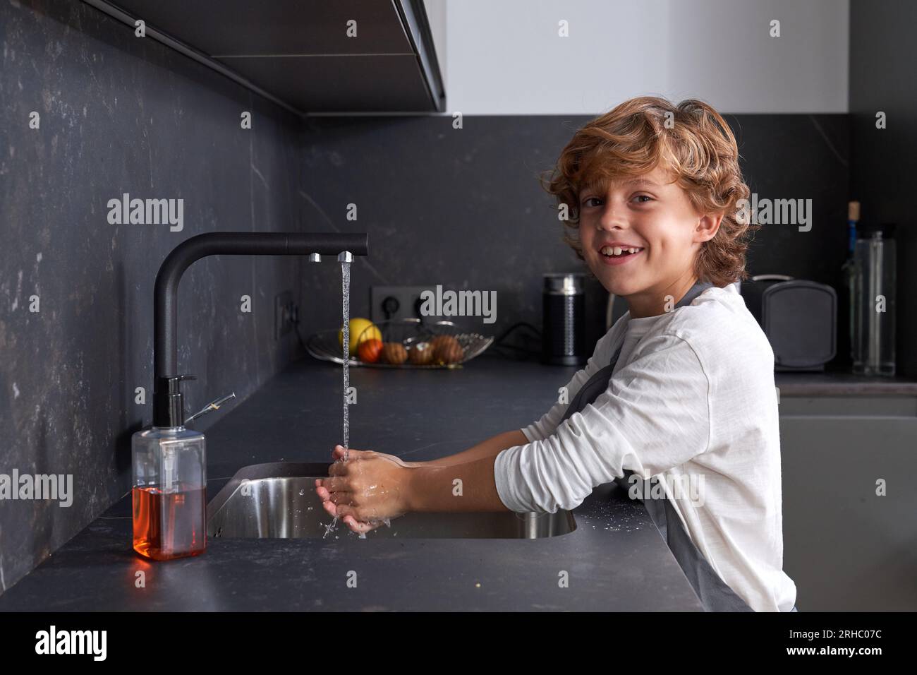 Boy pouring water kitchen hi-res stock photography and images - Alamy