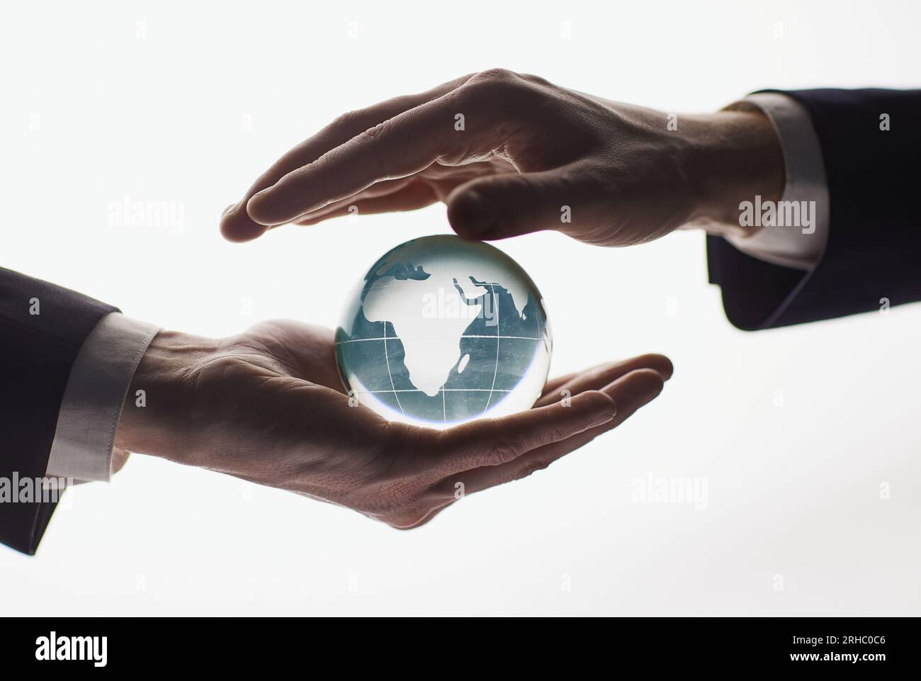earth in hands. Glass World, on a white background Stock Photo - Alamy