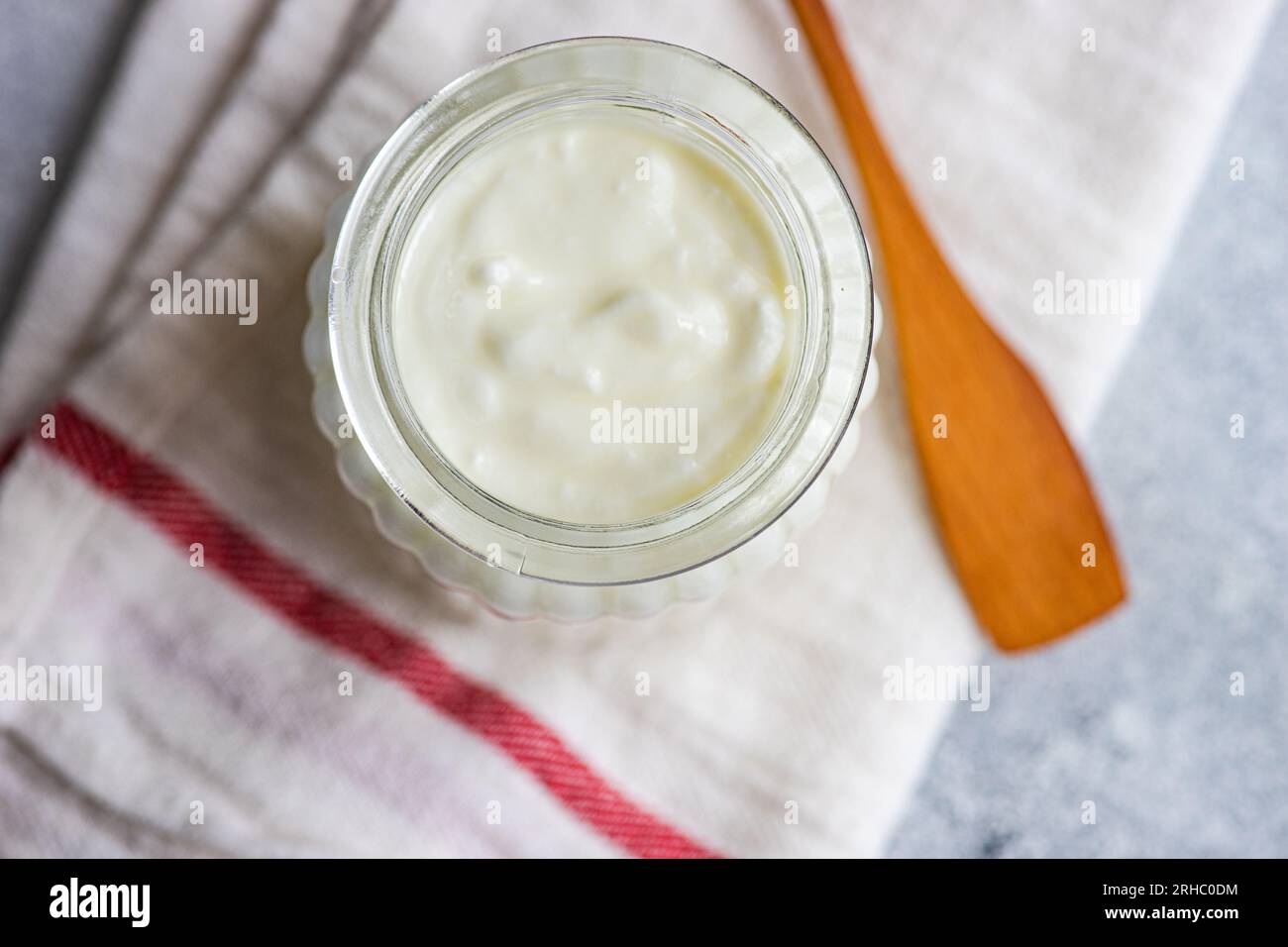 Overhead view of a glass jar with traditional fermented yogurt (matsoni ...