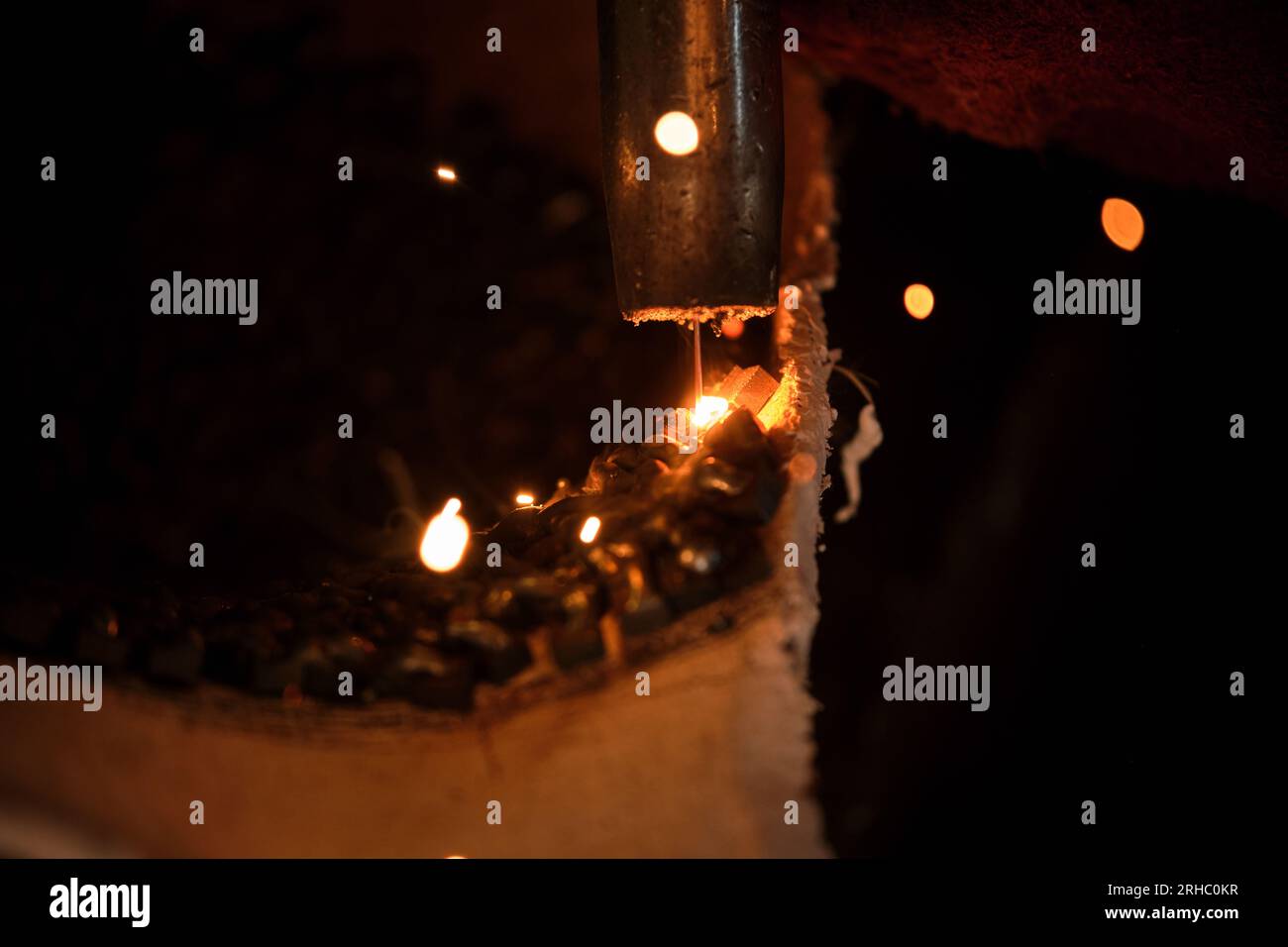 Closeup professional welding machine joining metal cubes with hot beam ...