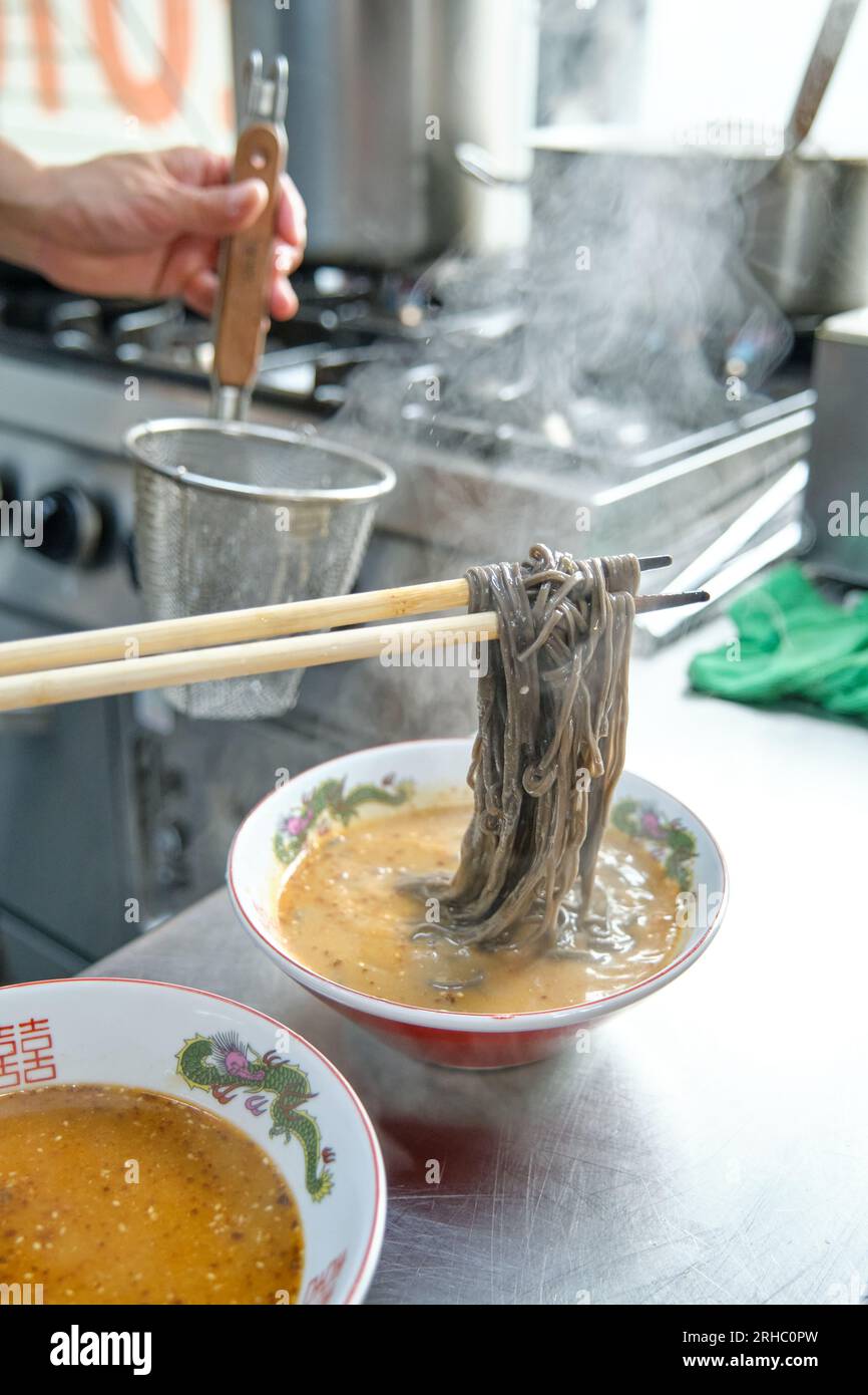 High angle of crop anonymous chef with stainless strainer basket and ...