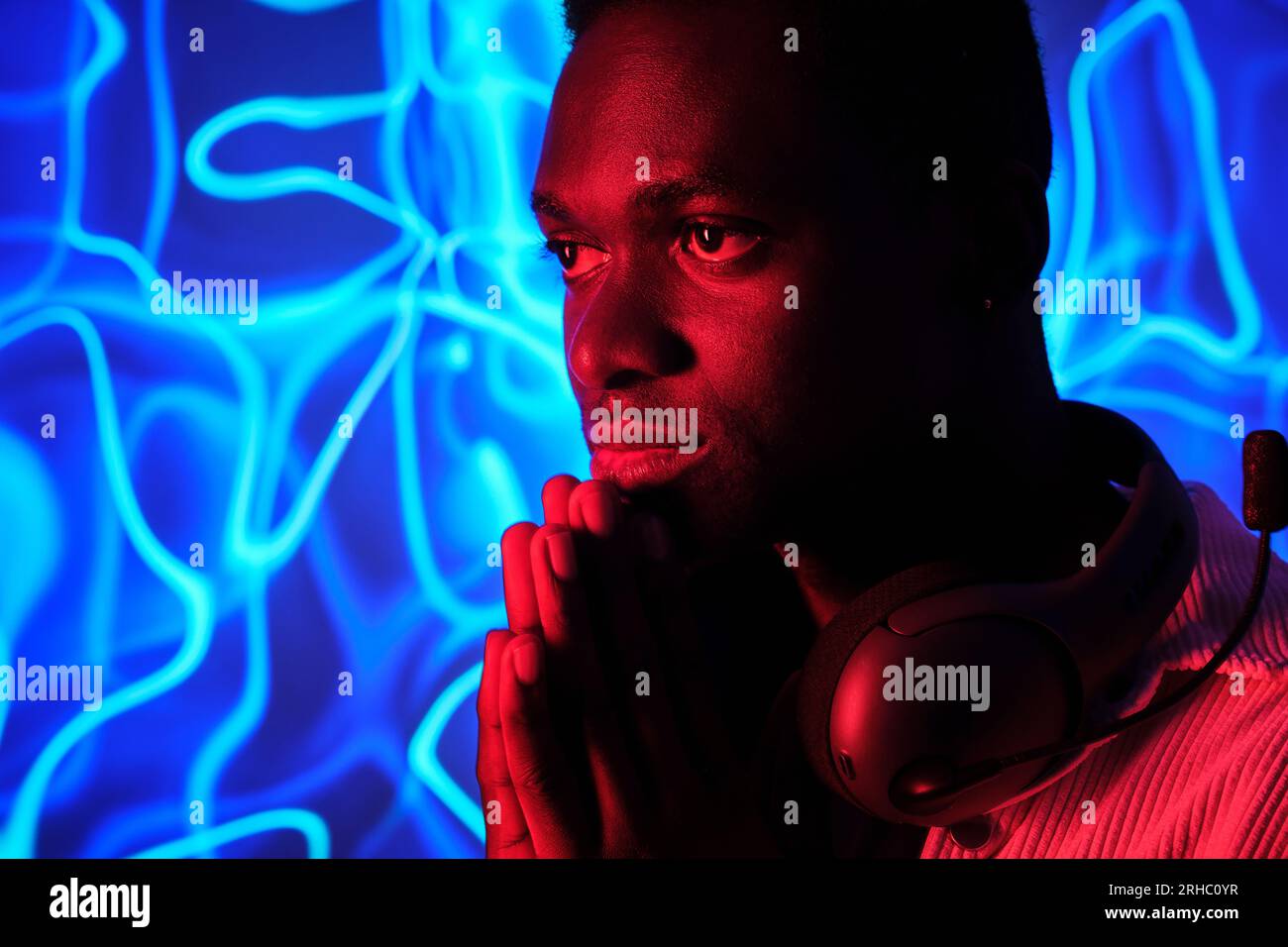 Crop African American male with headset on neck thinking with folded ...