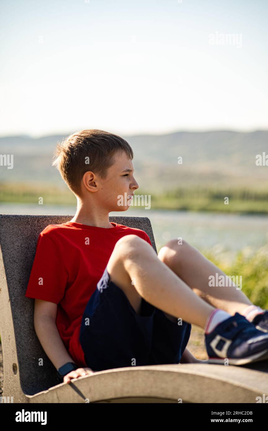 Side view boy sitting in chair hi-res stock photography and images - Alamy