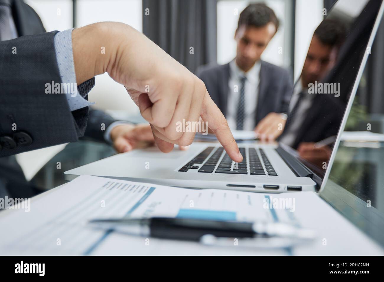 Men's hands are typing on a laptop keyboard against the background of ...