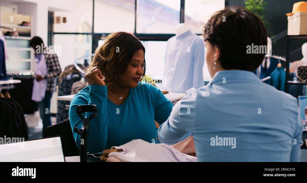 Caucasian worker scanning client items using store scanner in modern ...