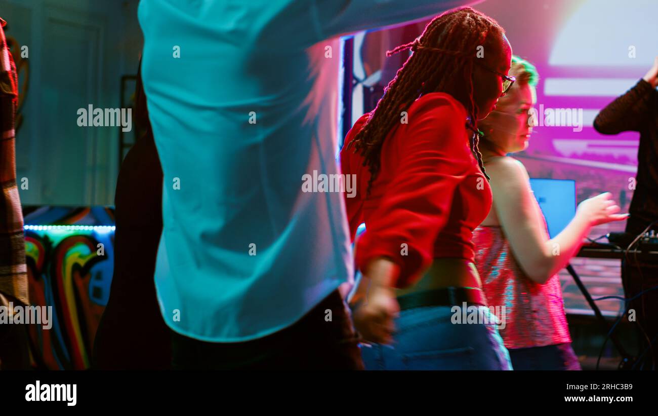 Multiethnic group of people dancing in discotheque, having fun together ...