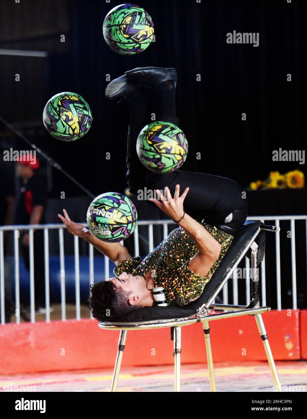 A performer entertains the crowd with his juggling skills during the ...