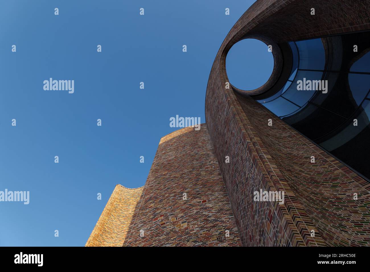 Vejle, Denmark - 06 OCTOBER 2022: Outdoor exterior view and detail of curvature brick wall and ...