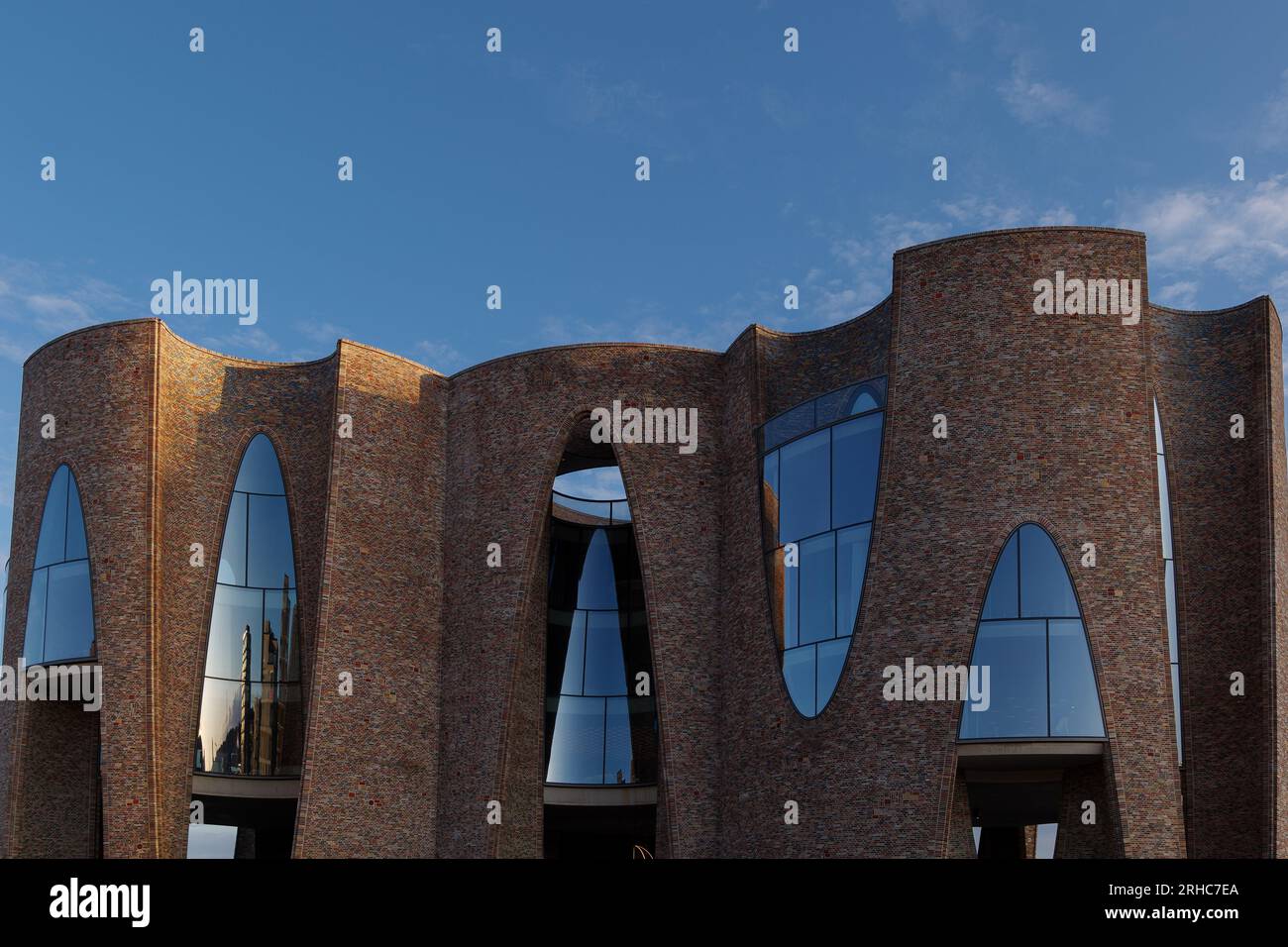 Vejle, Denmark - 06 OCTOBER 2022: Outdoor exterior view and detail of curvature brick wall and ...