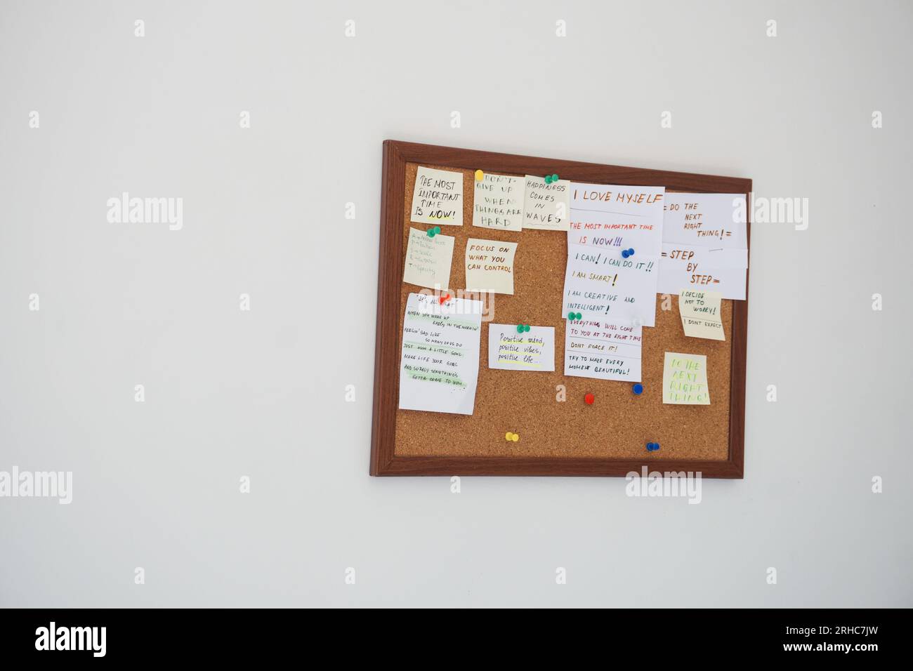 Cork board with stick notes with motivational sentences on them on a ...