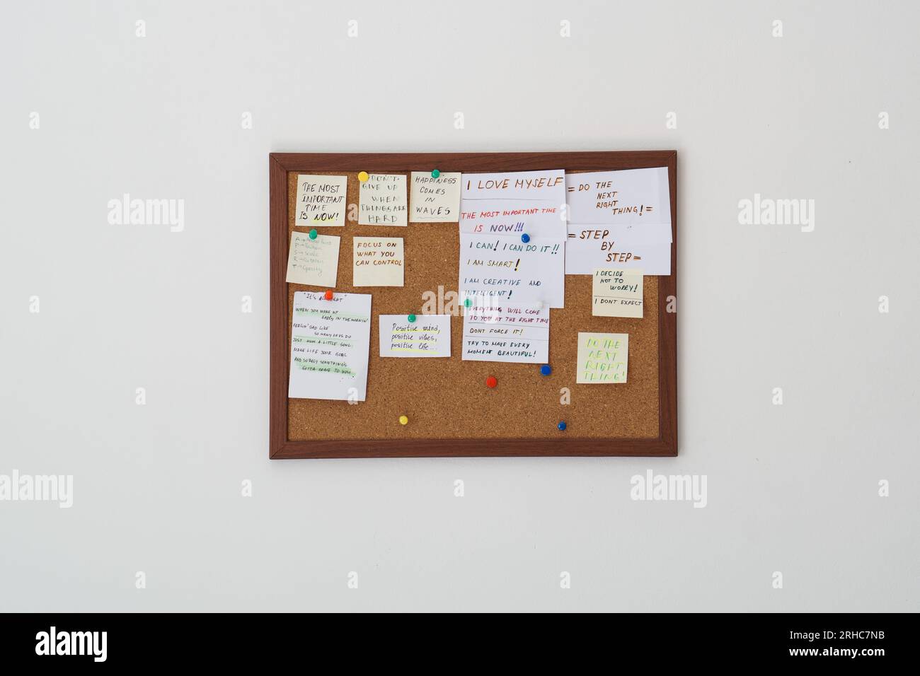 Cork board with stick notes with motivational sentences on them on a ...