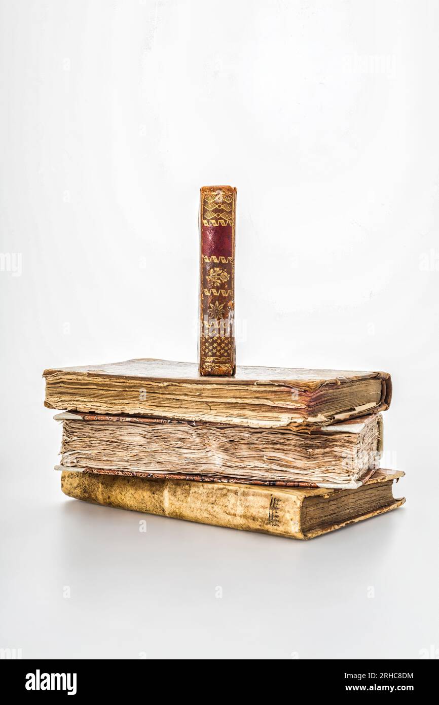 Aged books from past centuries, stacked together, all with intriguingly ...