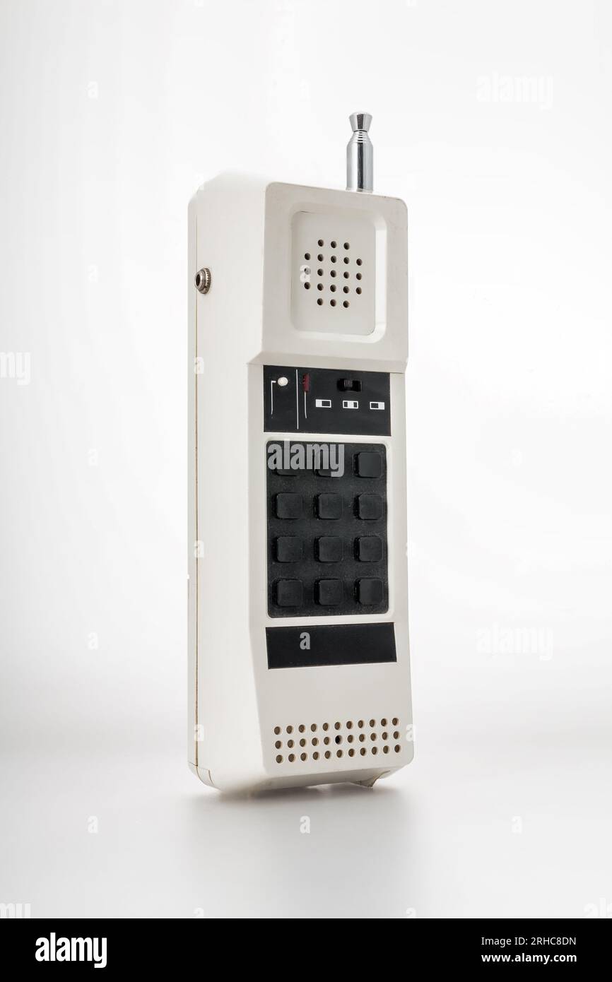 White cordless plastic phone with a metal telescopic antenna, a relic ...