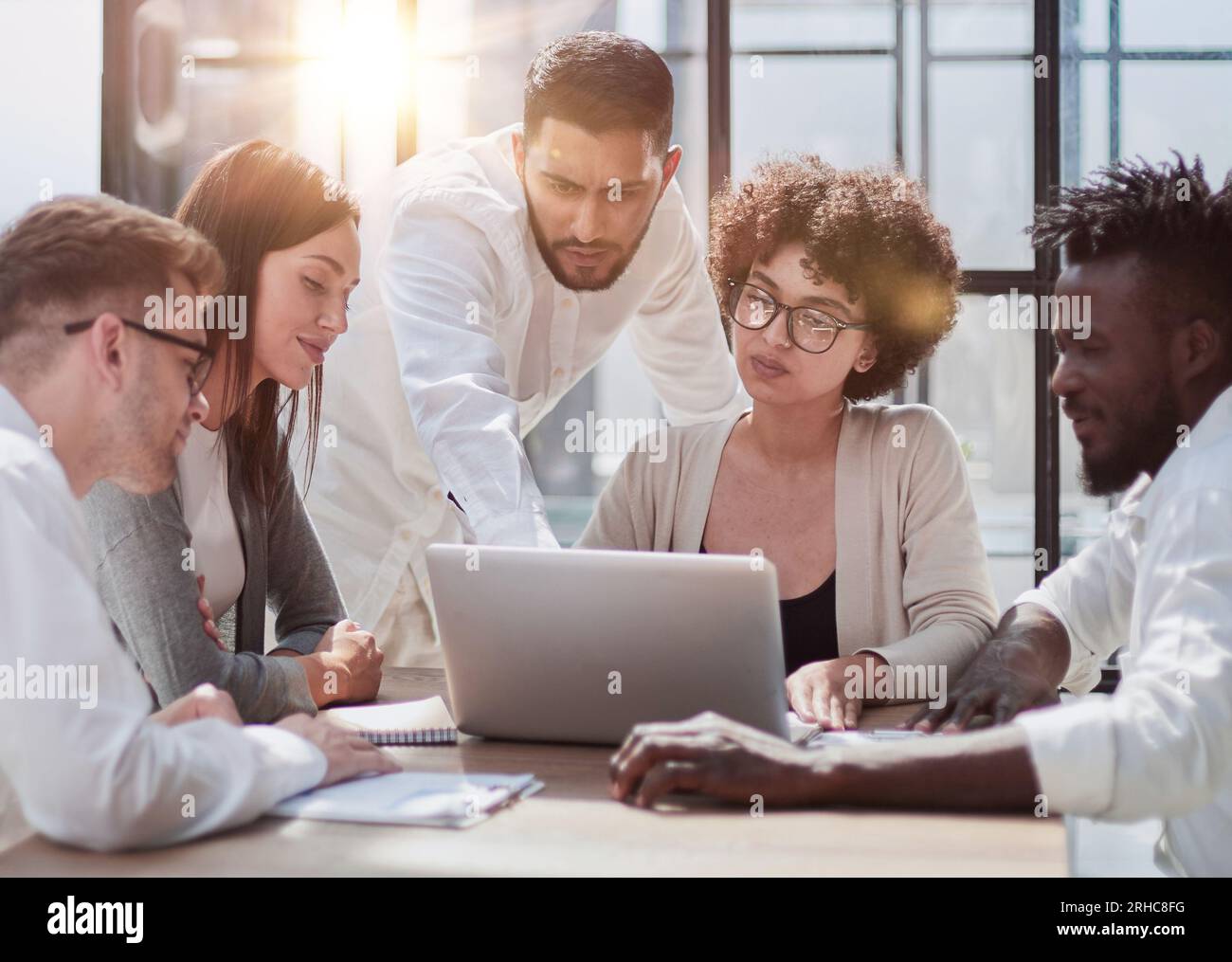Employees working at computer together, discussing content Stock Photo ...