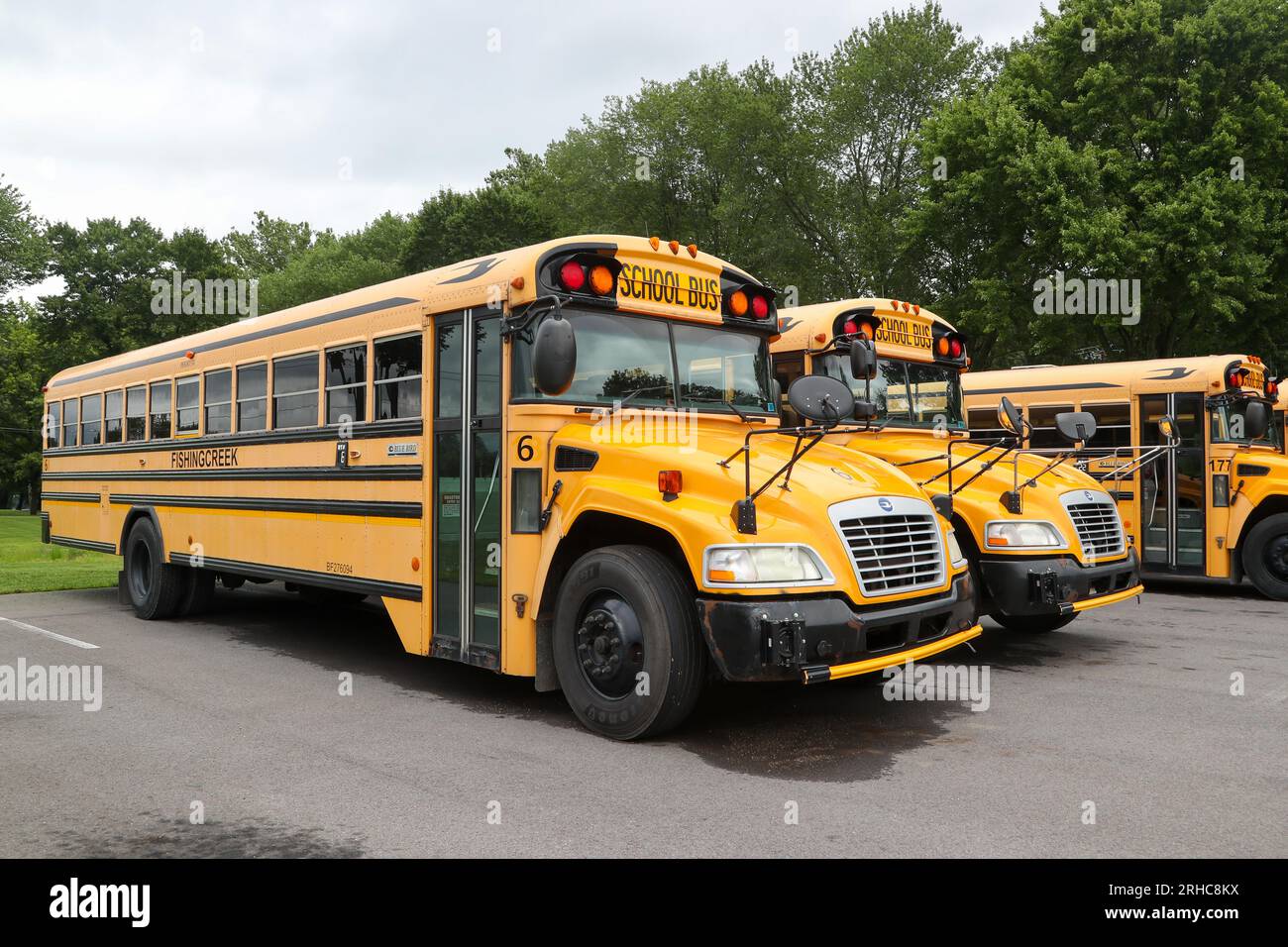 School buses are seen parked at Bloomsburg High School as many school ...