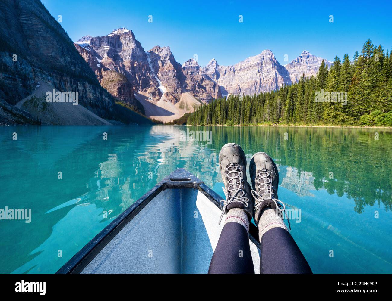 Hiker enjoying the morning in her Canoe, Moraine Lake during summer in Banff National Park ...