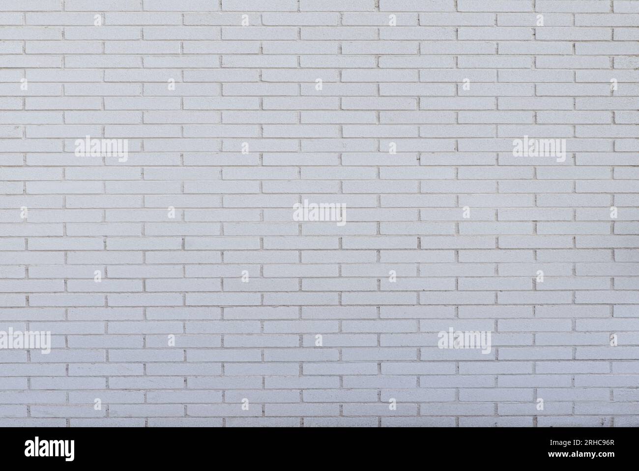 White brick wall joined with cement and with a lot of visual texture ...