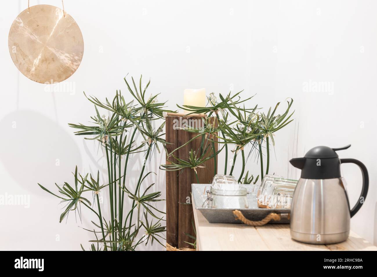 A corner of a room dedicated to making tea with a kettle and glass cups ...