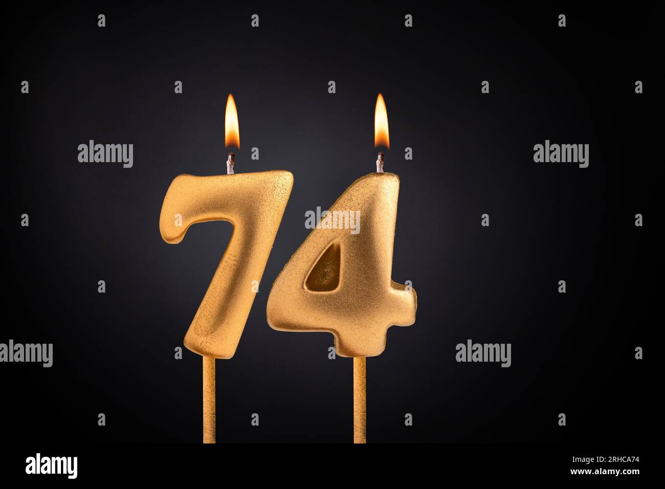 Birthday candle number 74 - Birthday celebration on black background ...