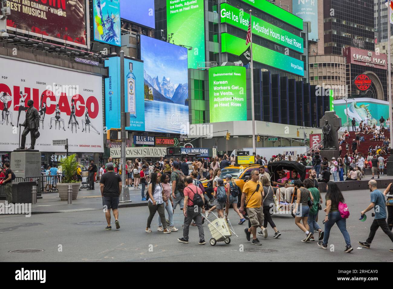 People cross West 46th Street at 7th Avenue in Times Square, New York ...