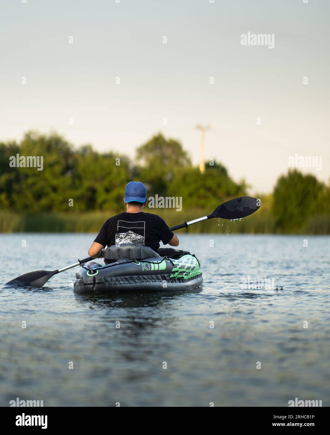 Professional photo of a young man kayaking in an inflatable kayak in a ...