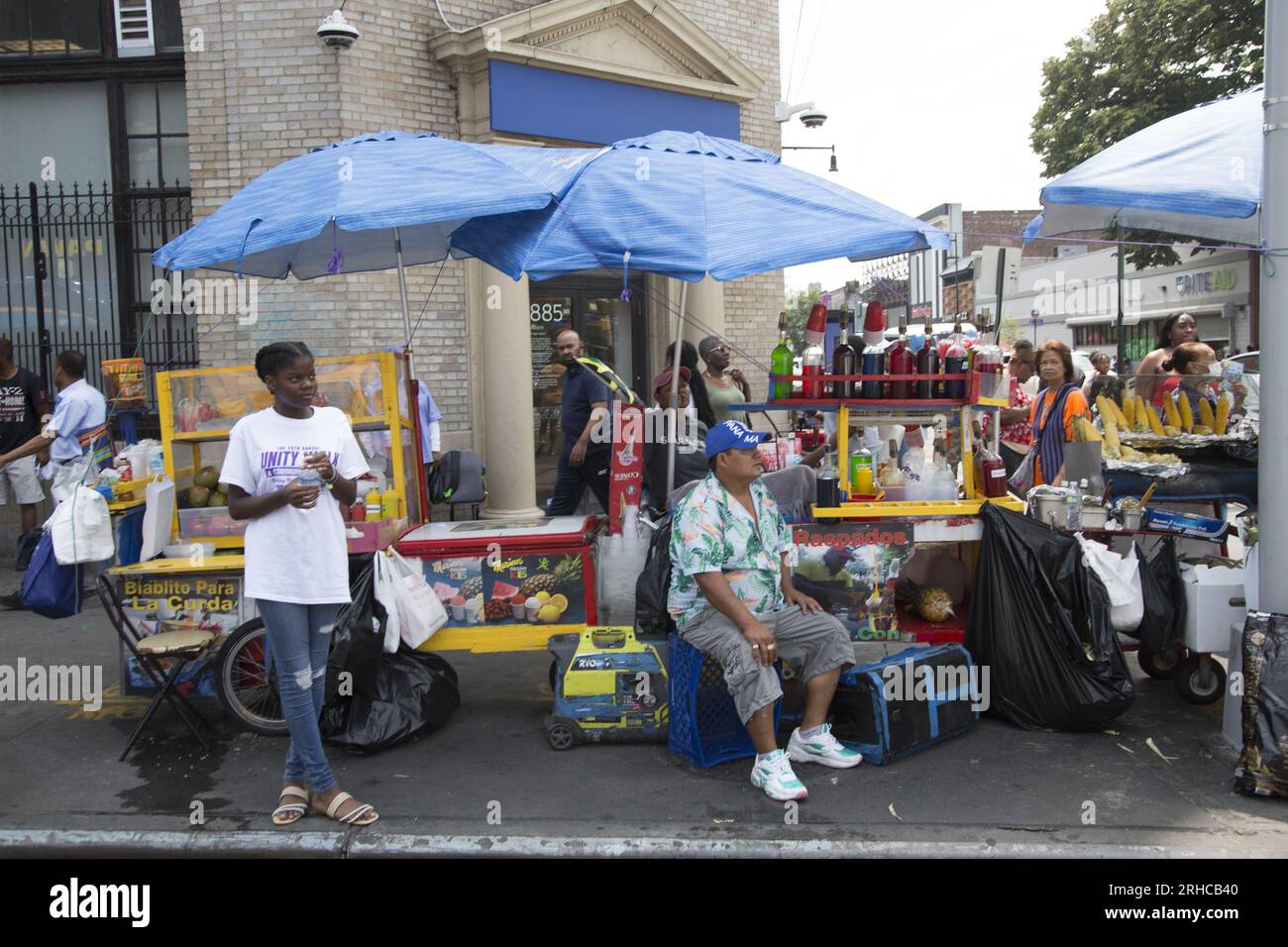 Local residents watch the Community Unity Parade along Flatbush Avenue ...