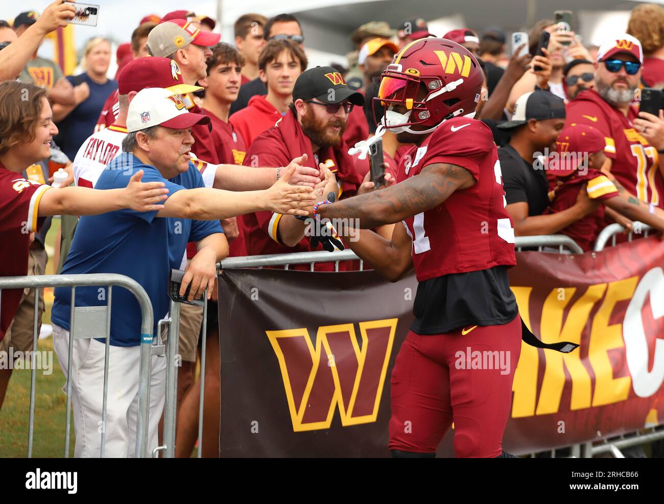 Washington Commanders cornerback Rachad Wildgoose (37) high fives fans ...