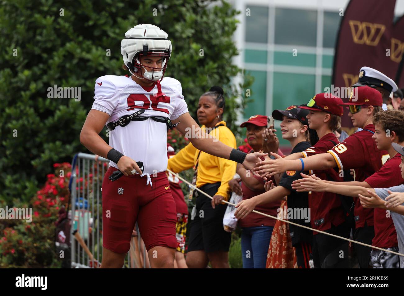 Washington Commanders tight end Cole Turner (85) high fives fans as he ...