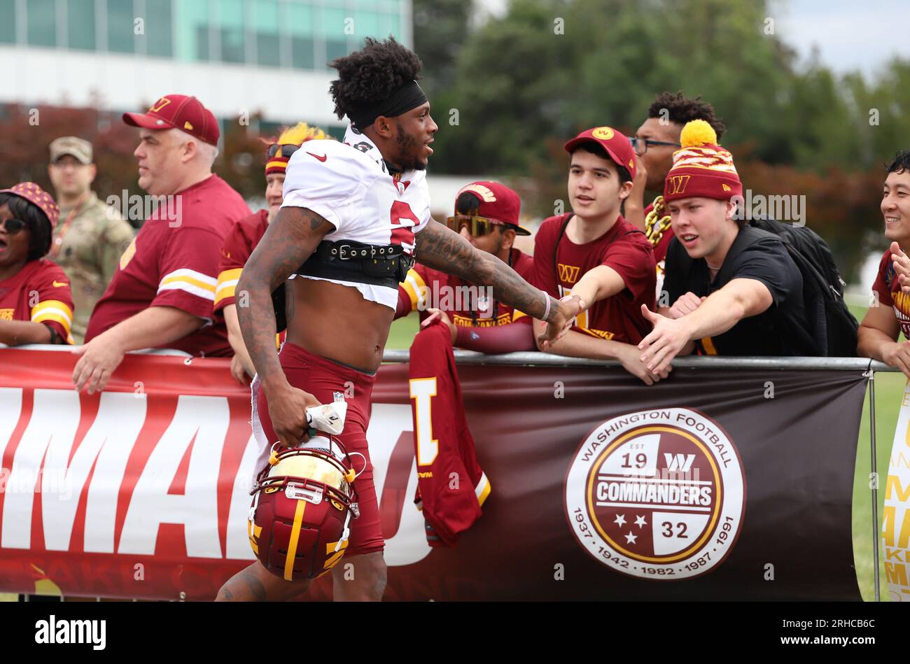 Washington Commanders wide receiver Dyami Brown (2) high fives fans as ...